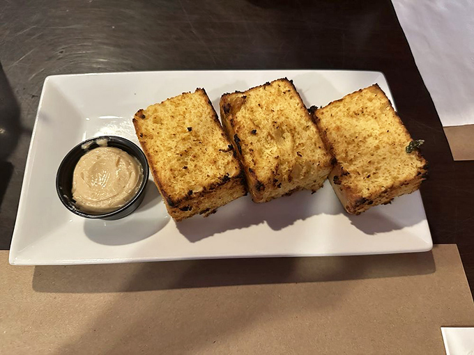 Golden cornbread squares with a side of something delicious for dipping. Carbs this good deserve their own holiday.