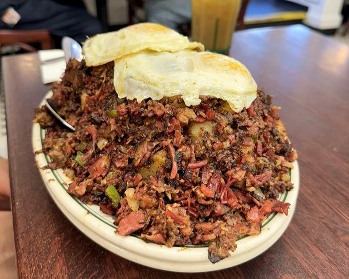 Corned beef hash that looks like it's plotting a delicious rebellion against boring breakfasts everywhere. Those eggs never stood a chance.