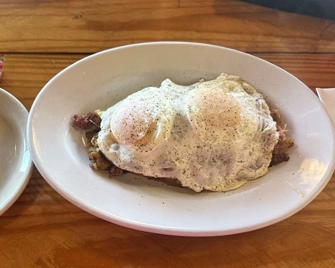 The holy trinity of breakfast: perfectly cooked eggs, crispy hash, and a promise that your day can only get better from here.