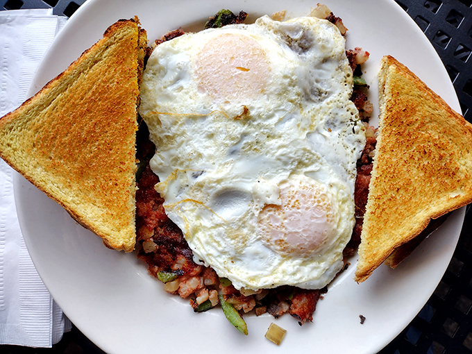 Corned beef hash crowned with perfectly sunny eggs and golden toast - the breakfast that says "today might be tough, but at least it started right."