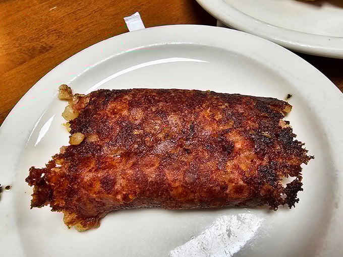 Corned beef hash with the perfect crisp-to-tender ratio. This isn't just breakfast&mdash;it's a morning masterpiece on a plain white plate.