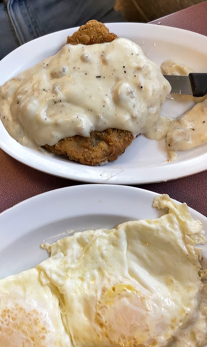 Country fried steak smothered in gravy with eggs below. When breakfast decides to dress up formal but keeps its comfortable shoes on.