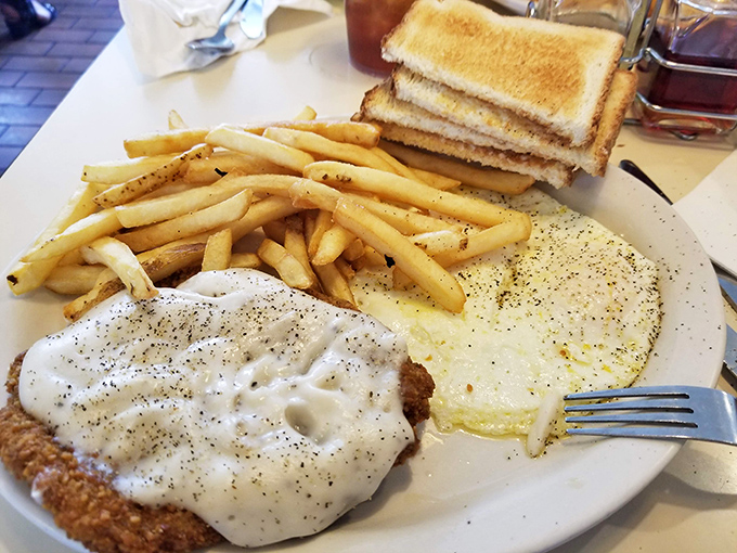Country fried steak swimming in pepper-flecked gravy &ndash; comfort food so sincere it could make a therapist obsolete.