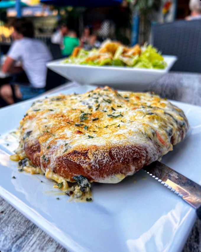 The Crabby Pretzel redefines indulgence with its blanket of melted cheese and seafood. Diet plans come here to die happy.