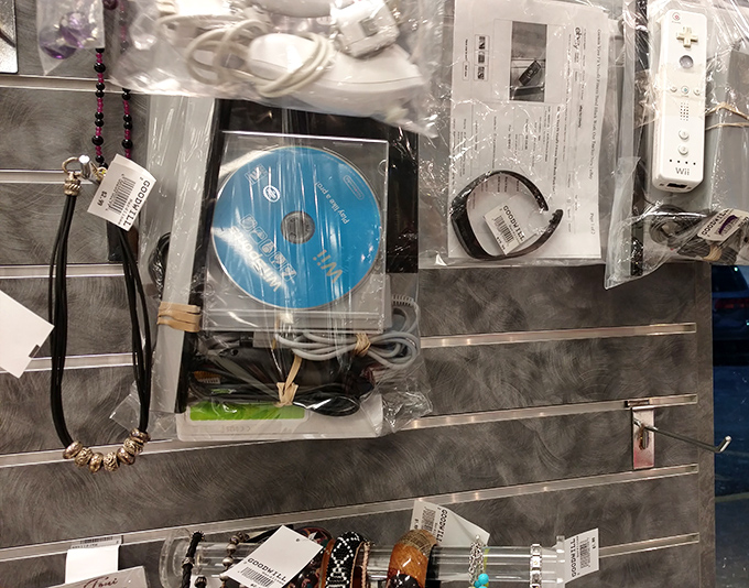 Behind glass, yesterday's accessories await new wrists and necks. That necklace might have attended a prom in 1998 or a wedding in 2005.