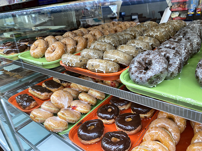 Donuts in their natural habitat&mdash;glistening with glaze, perfectly arranged, and silently judging your willpower from behind the glass.