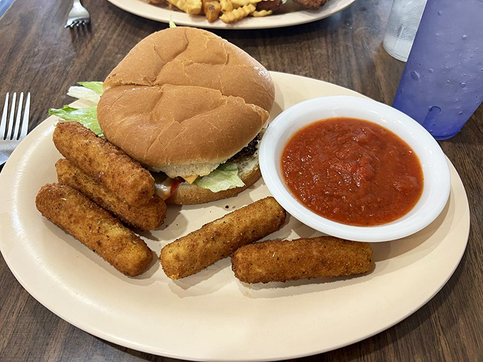 This isn't just a cheeseburger; it's the reason drive-thrus will never replace proper diners &ndash; melty cheese, fresh veggies, and fries worth stealing from your spouse's plate.