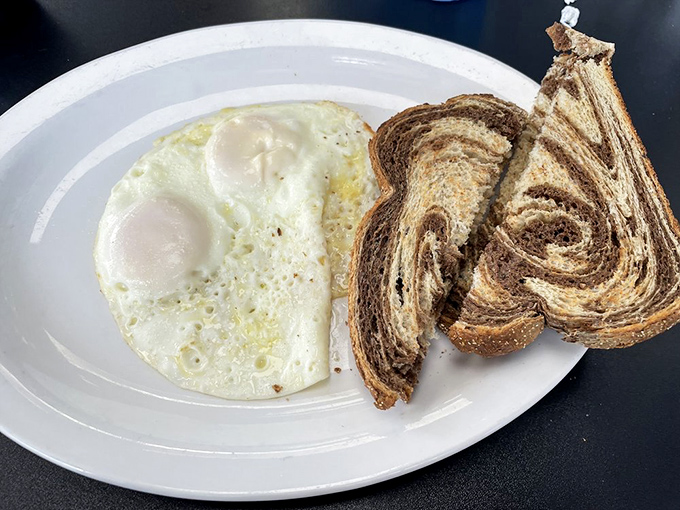 Two sunny-side up eggs with marble rye toast&mdash;proof that sometimes the simplest breakfasts are life's greatest luxuries.