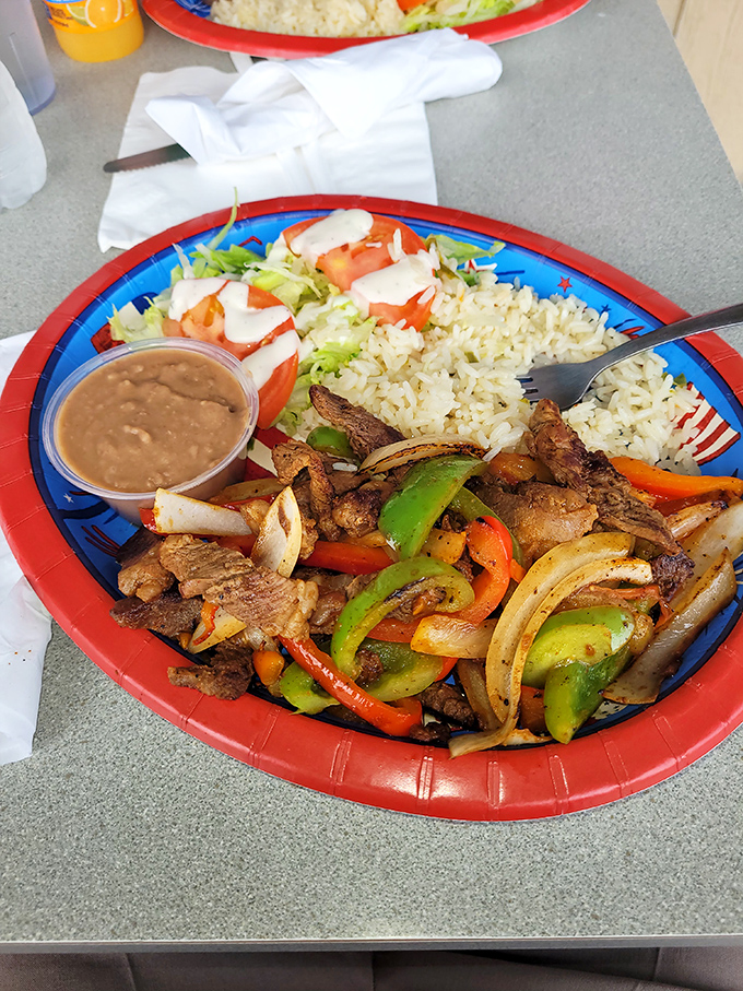 A fajita plate that sizzles with personality&mdash;colorful bell peppers and onions dancing with perfectly seasoned meat while rice and beans watch from the sidelines.