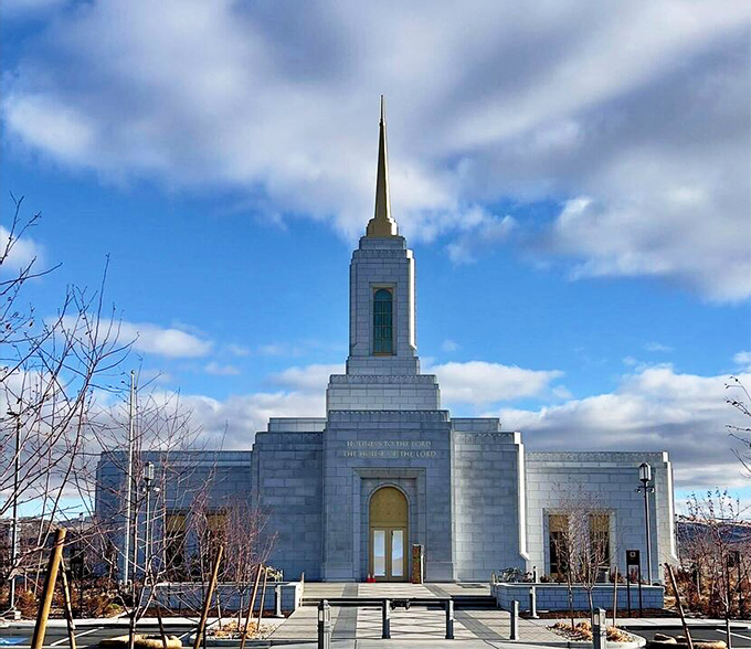 The Elko Nevada Temple stands as a serene architectural counterpoint to the rugged landscape, its white exterior gleaming against the high desert sky.