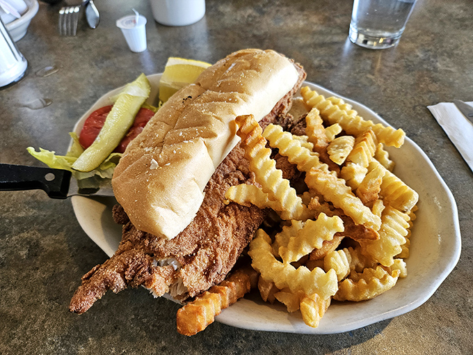 The fish sandwich arrives with an honor guard of crispy fries. It's the kind of simple pleasure that makes you wonder why you ever bother with fancy restaurants.