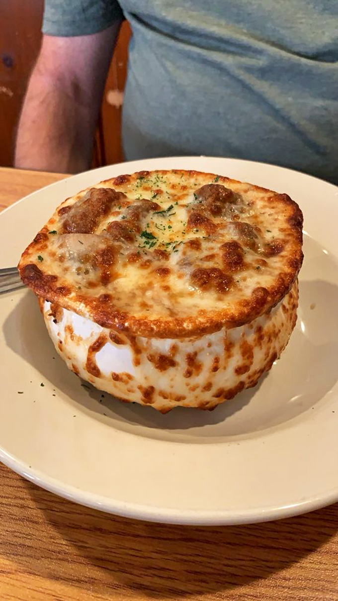 French onion soup that's wearing its cheese crown with pride. The battle between your spoon and that stretchy topping is one worth fighting.