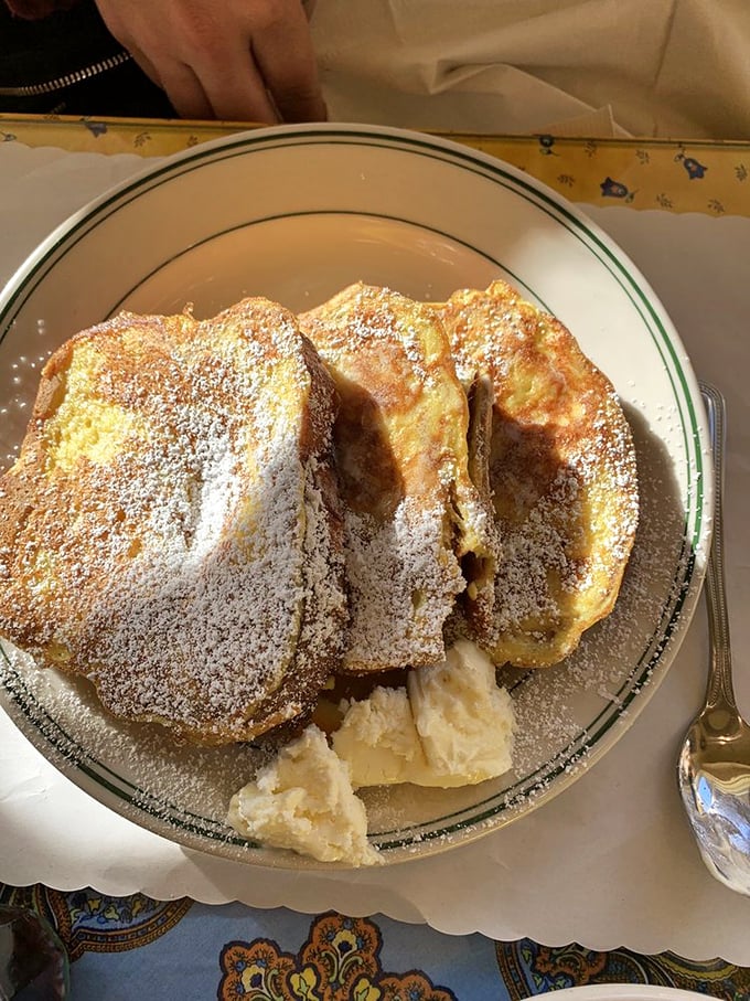 French toast that makes you question every other breakfast you've ever had. Dusted with powdered sugar like the first snow of winter.