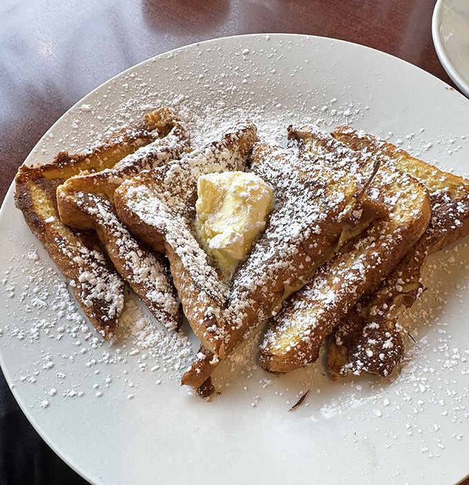 French toast that's dressed for success&mdash;crisp edges, custardy centers, and enough powdered sugar to make your coffee jealous.
