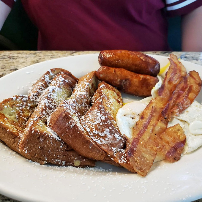 French toast that makes you question why anyone bothers with fancy brunch. Add sausage and bacon, and you've got breakfast heaven on a plate.