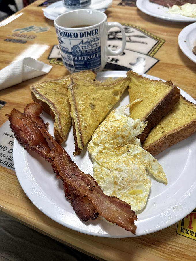 French toast that's been given the royal treatment. Crispy edges, custardy centers, and strips of bacon that somehow manage to be both crisp and chewy in all the right places.