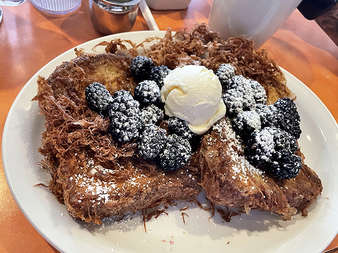 French toast that's gone to finishing school&mdash;crispy exterior, custardy interior, and berries that pop like edible jewels.