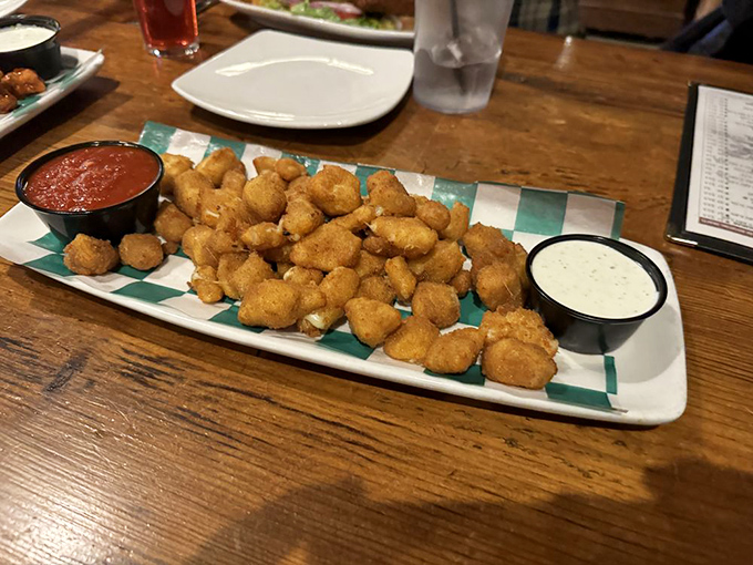 These aren't just any cheese curds &ndash; they're little golden nuggets of happiness, served with dipping sauces that make you question why you'd ever eat them any other way.