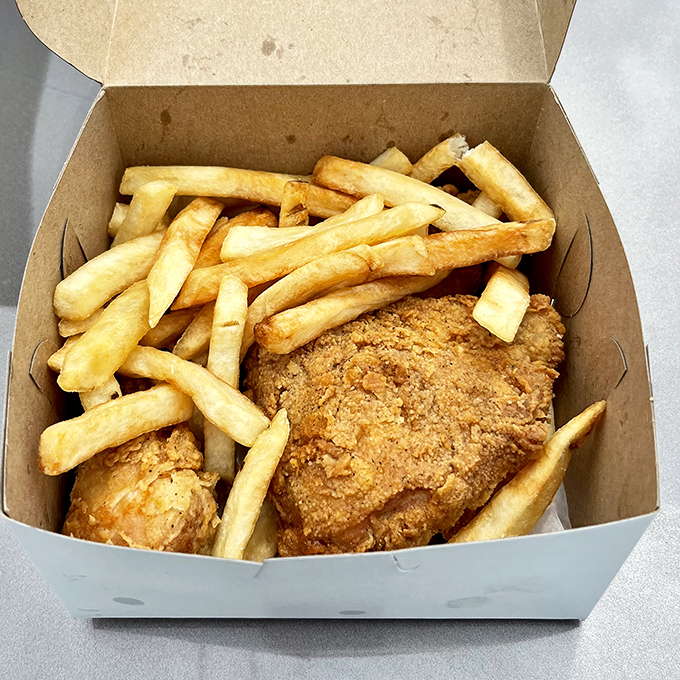 The humble to-go box—nature's perfect delivery system for transporting crispy chicken and fries from Fast Eddie's to your eagerly waiting mouth.