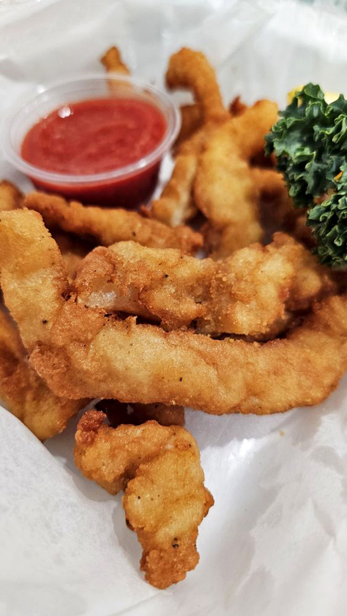 Golden-fried conch strips that crunch like your favorite childhood snack but taste like the ocean's finest gift.