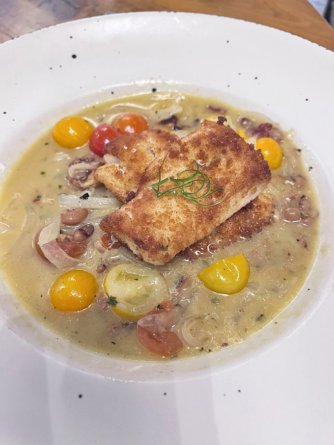 Comfort in a bowl – tender morsels swimming in a creamy broth dotted with colorful vegetables and topped with crusty bread. Spoon-licking guaranteed.