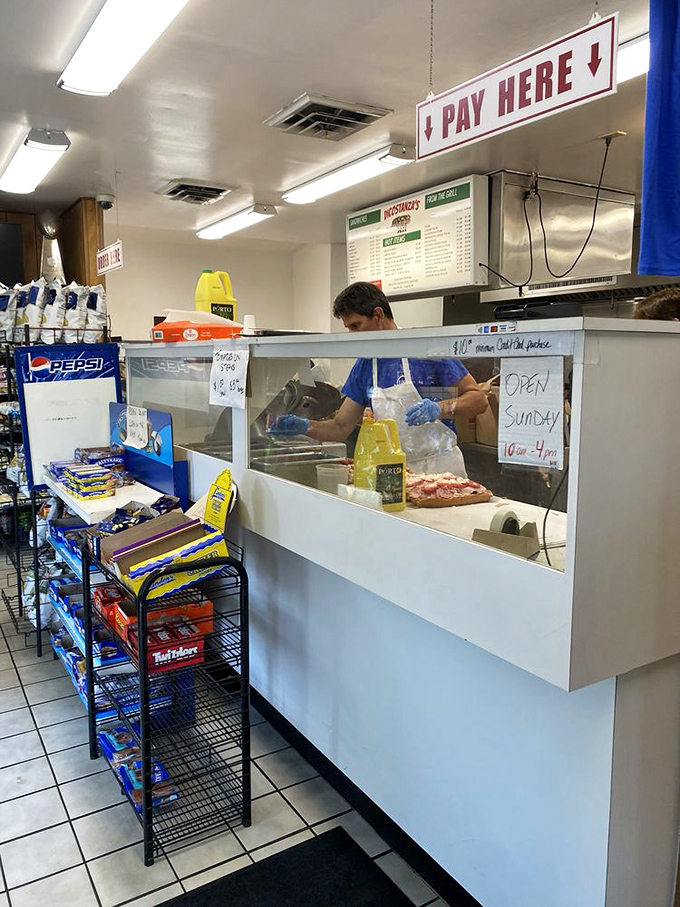 Behind this counter, sandwich magic happens daily. The "Pay Here" sign might as well read "Happiness Dispensed Here" for those in the know.