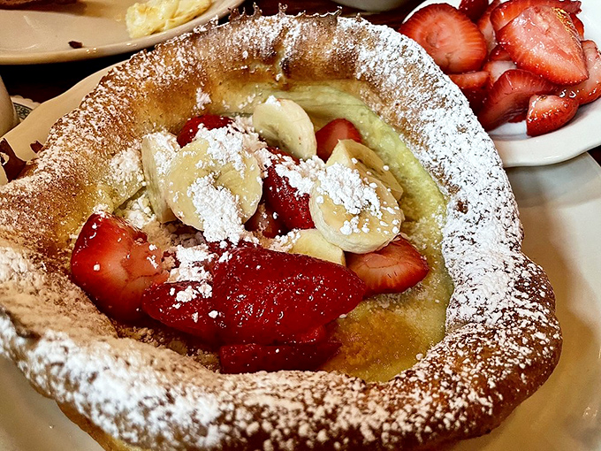 The German Pancake arrives looking like a crater filled with fruit and powdered sugar &ndash; a breakfast landscape you'll want to explore bite by bite.