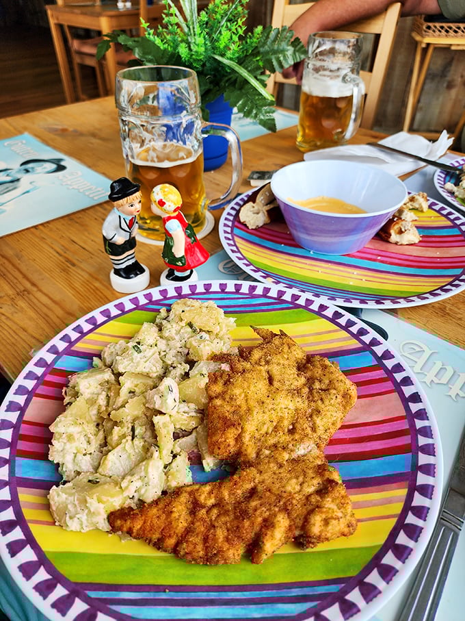 The famous potato salad sharing plate space with golden schnitzel&mdash;this is the culinary equivalent of finding a beachside lounger during spring break: pure Florida-German magic.
