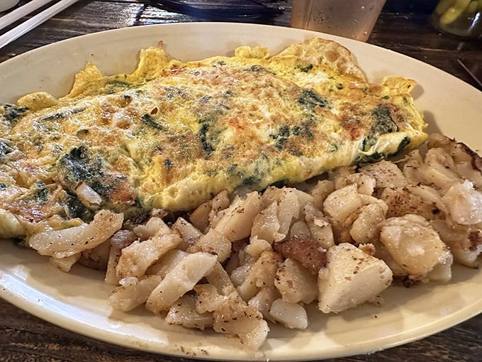 This omelet doesn't just sit on the plate &ndash; it commands attention with its fluffy perfection, while those home fries play the delicious supporting role.