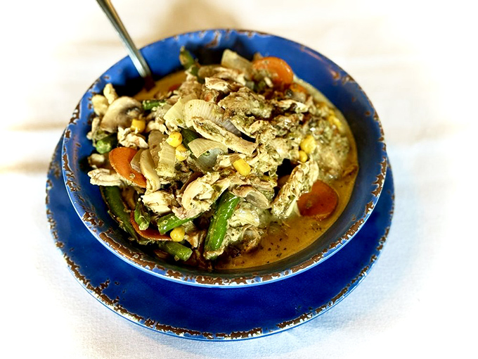 A vibrant bowl of curry packed with fresh vegetables and tender chicken&mdash;proof that comfort food speaks a universal language.