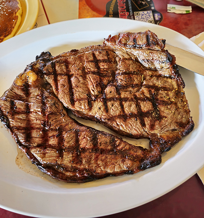 Steak with perfect grill marks that would make a backyard BBQ champion weep with envy. Carnivore poetry on a plate.