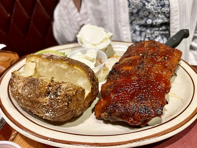 This half slab of ribs with a baked potato looks like what Fred Flintstone would order if he had a corporate expense account.