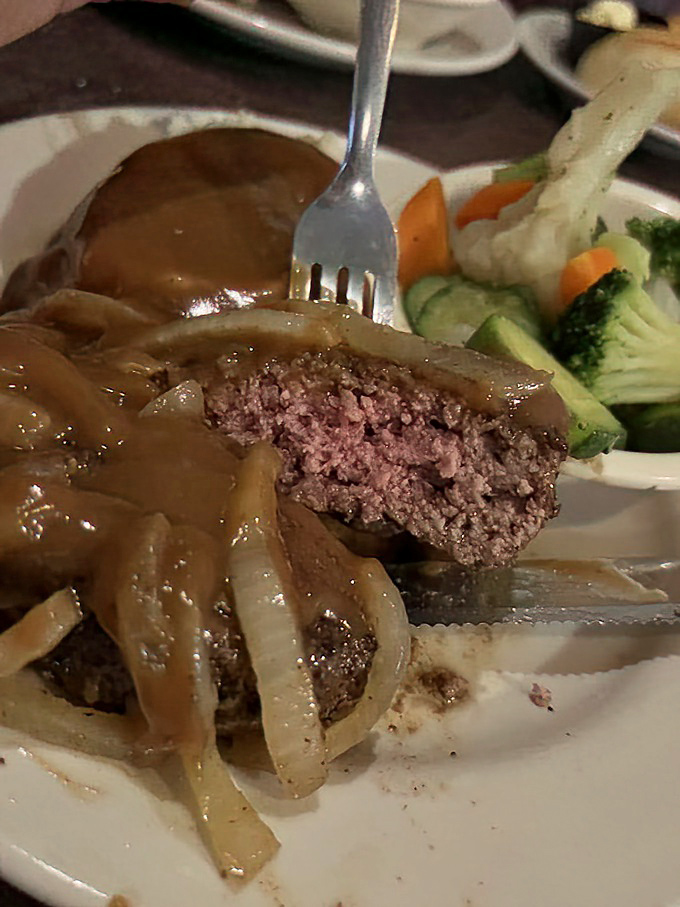 The hamburger steak hiding beneath those caramelized onions isn't playing games&mdash;it's serious comfort food with a side of nostalgia.