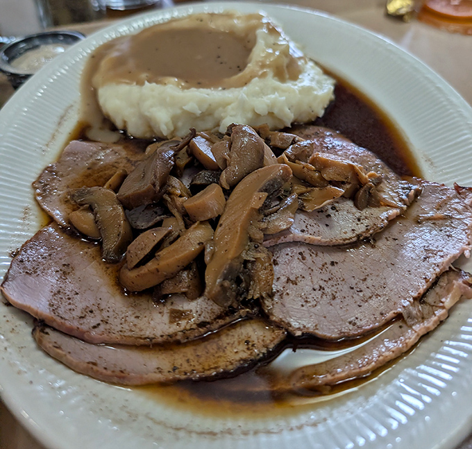 Roast beef so tender it practically surrenders to your fork, swimming in a rich au jus with mushrooms that mean business.