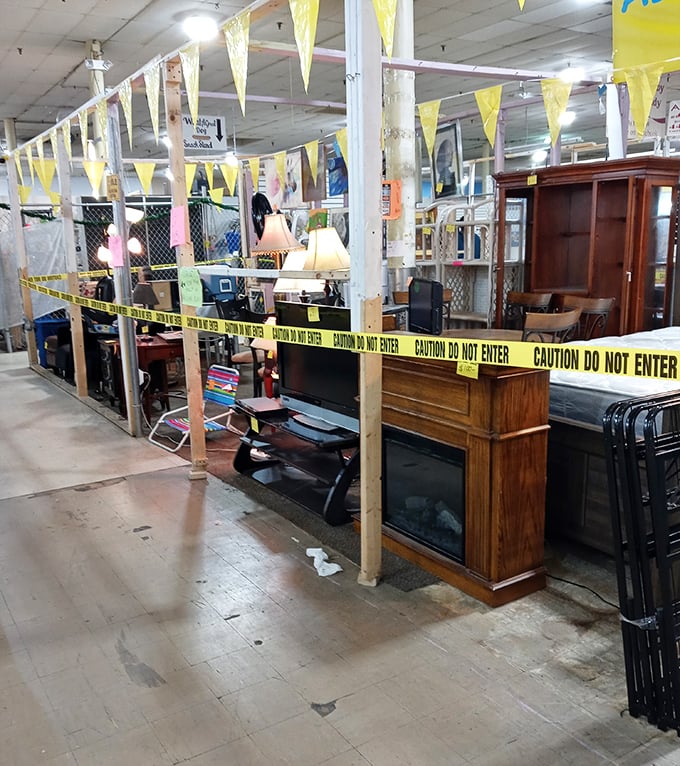The furniture section: where caution tape creates the world's most intriguing VIP area for vintage desks and forgotten armoires.