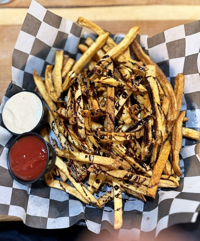 Crispy potatoes that could make a French fry jealous, alongside a sandwich that's achieved perfect golden-brown status. The orange slice adds a wink of brightness.