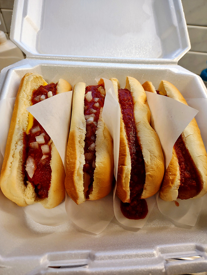 Coney dogs lined up like soldiers ready for delicious duty, their red sauce and diced onions standing at attention. Take-out never looked so temptingly traditional.