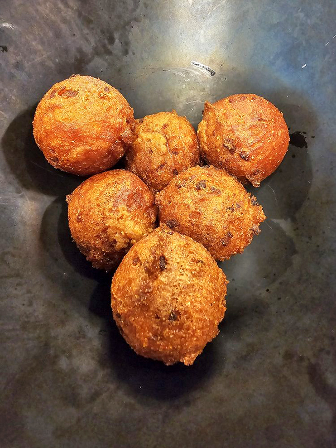 Hushpuppies so perfectly golden they deserve their own Instagram account – crispy exterior giving way to a tender, flavorful interior that defies physics.