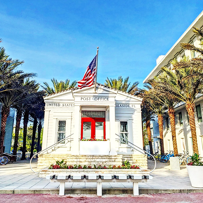 America's most photogenic post office stands proud in crisp white with its red door, proving even sending postcards becomes a charming experience in Seaside.