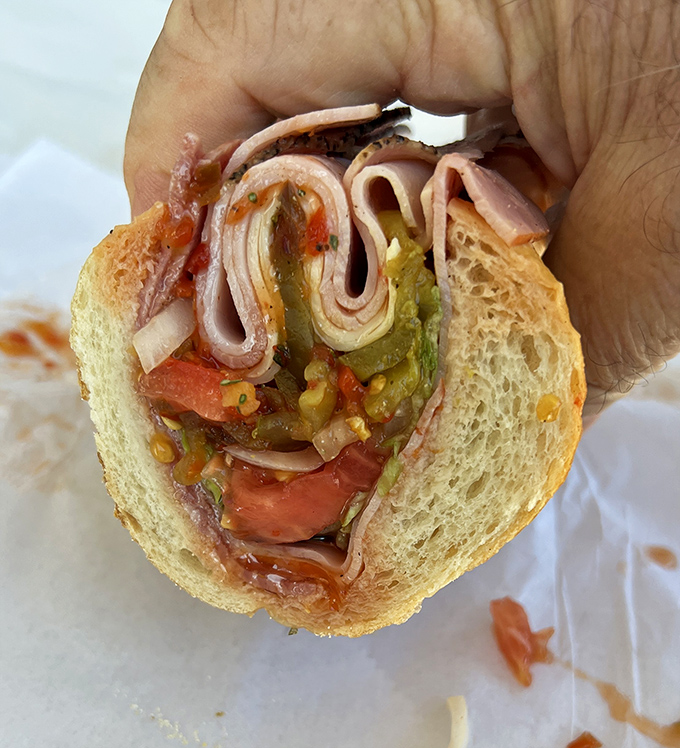 The Italian sub cross-section reveals the geological layers of deliciousness – meats, cheese, veggies, and that perfect oil and vinegar soak.