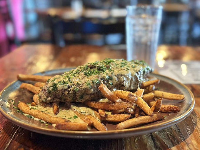 Johnny's steak doesn't just sit on those fries &ndash; it lounges like it owns the place. That cream sauce is practically begging for a spoon.