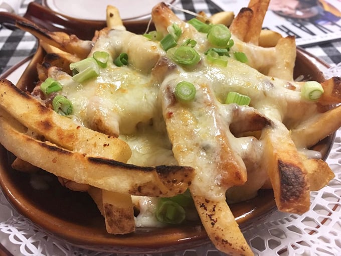 These aren't just cheese fries&mdash;they're an engineering marvel. Crispy potato foundations supporting melted cheese and green onions in perfect harmony.
