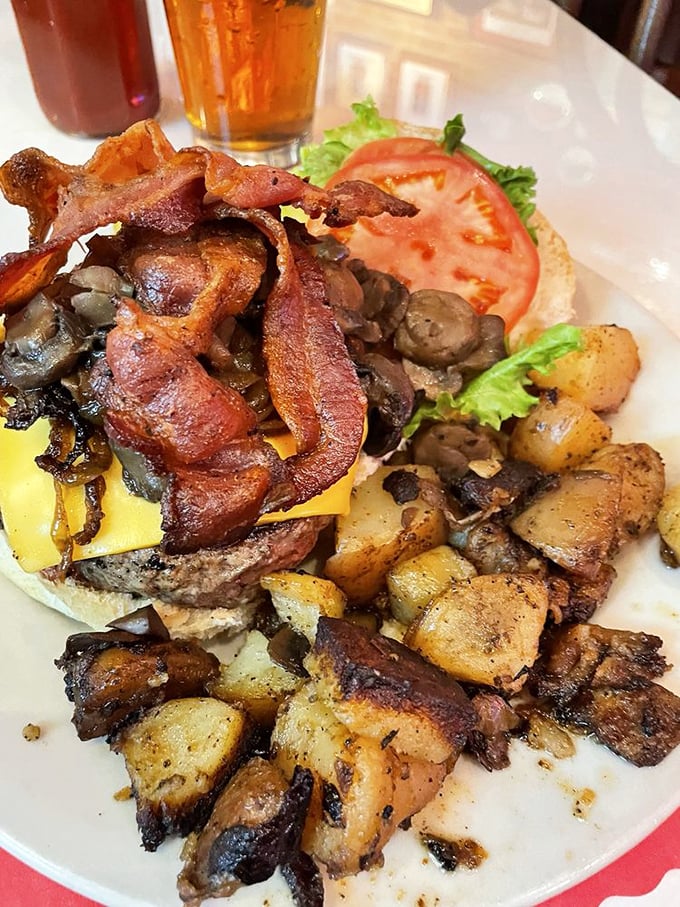 The Kelly Burger arrives like a meaty celebrity, surrounded by bacon, grilled onions and mushrooms&mdash;the burger equivalent of having an entourage.