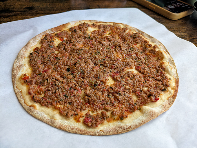 The humble flatbread reimagined as a canvas for savory artistry&mdash;this lahmacun proves that sometimes the simplest dishes speak the loudest.