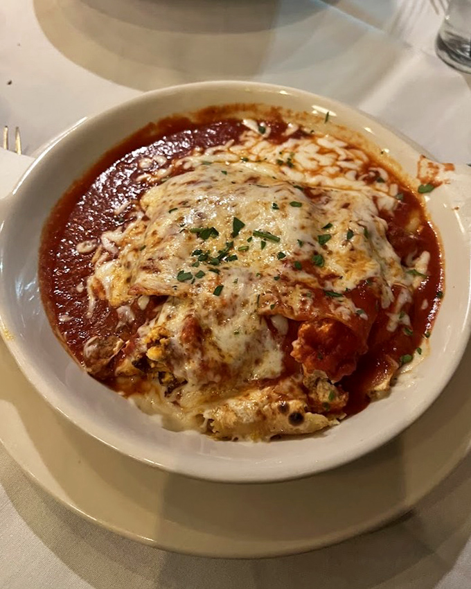 Lasagna that doesn't know the meaning of restraint—cheese pulling a disappearing act as you dig into layers of comfort that could solve world peace.