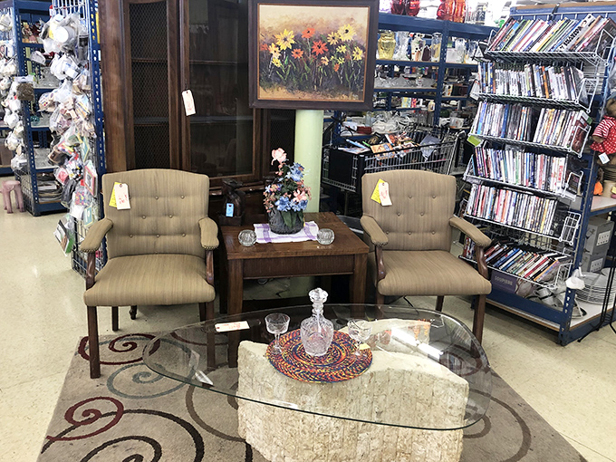 A living room vignette that's one man's discard and another's mid-century modern dream. That glass coffee table has stories to tell.