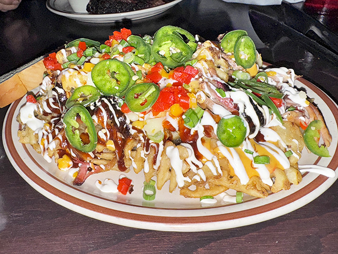 These loaded nachos aren't just a dish—they're an architectural achievement. The jalapeños stand guard over treasures of meat and cheese below.