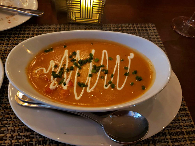 A soup so luxurious it probably has its own accountant. That swirl of cream is basically the signature on a masterpiece.
