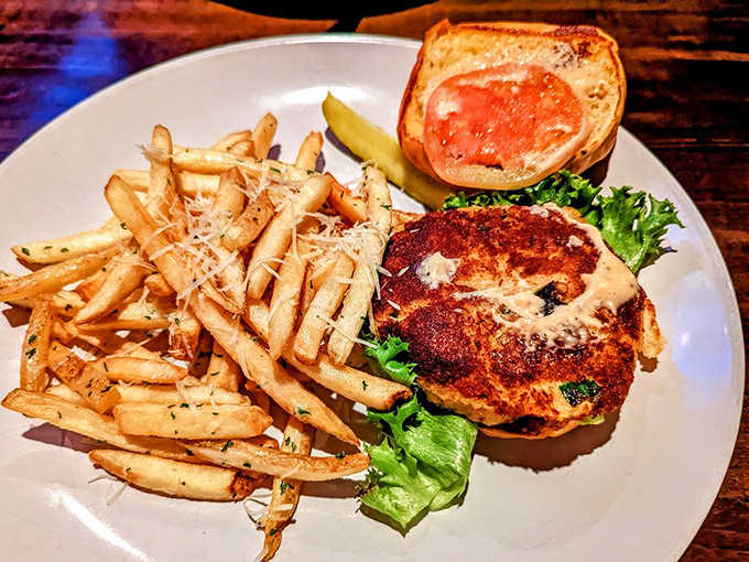 Golden fries dusted with herbs alongside a sandwich that proves sometimes the best things in life come between two pieces of bread.