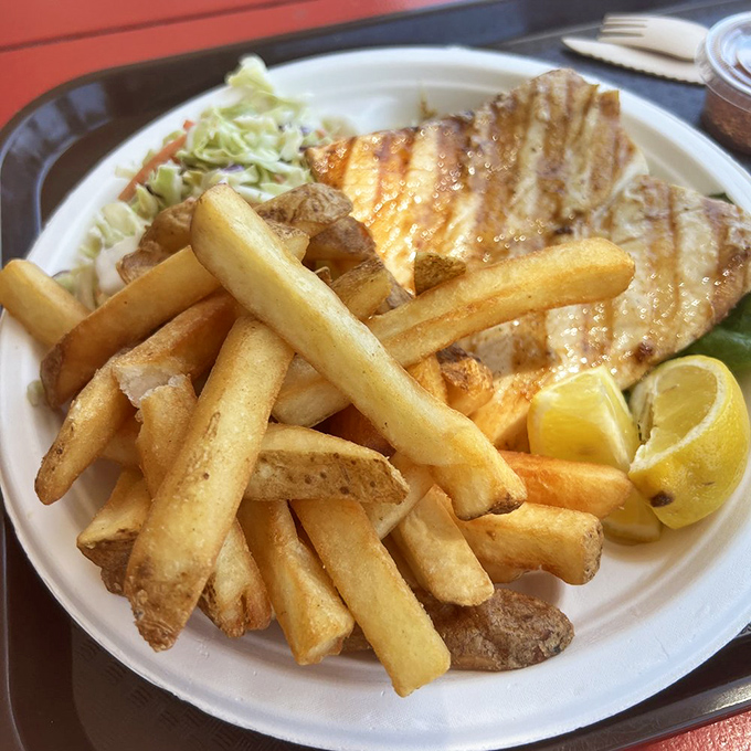 Perfectly grilled mahi-mahi with golden fries and crisp slaw&mdash;proof that sometimes the simplest preparation lets great seafood speak its delicious truth.